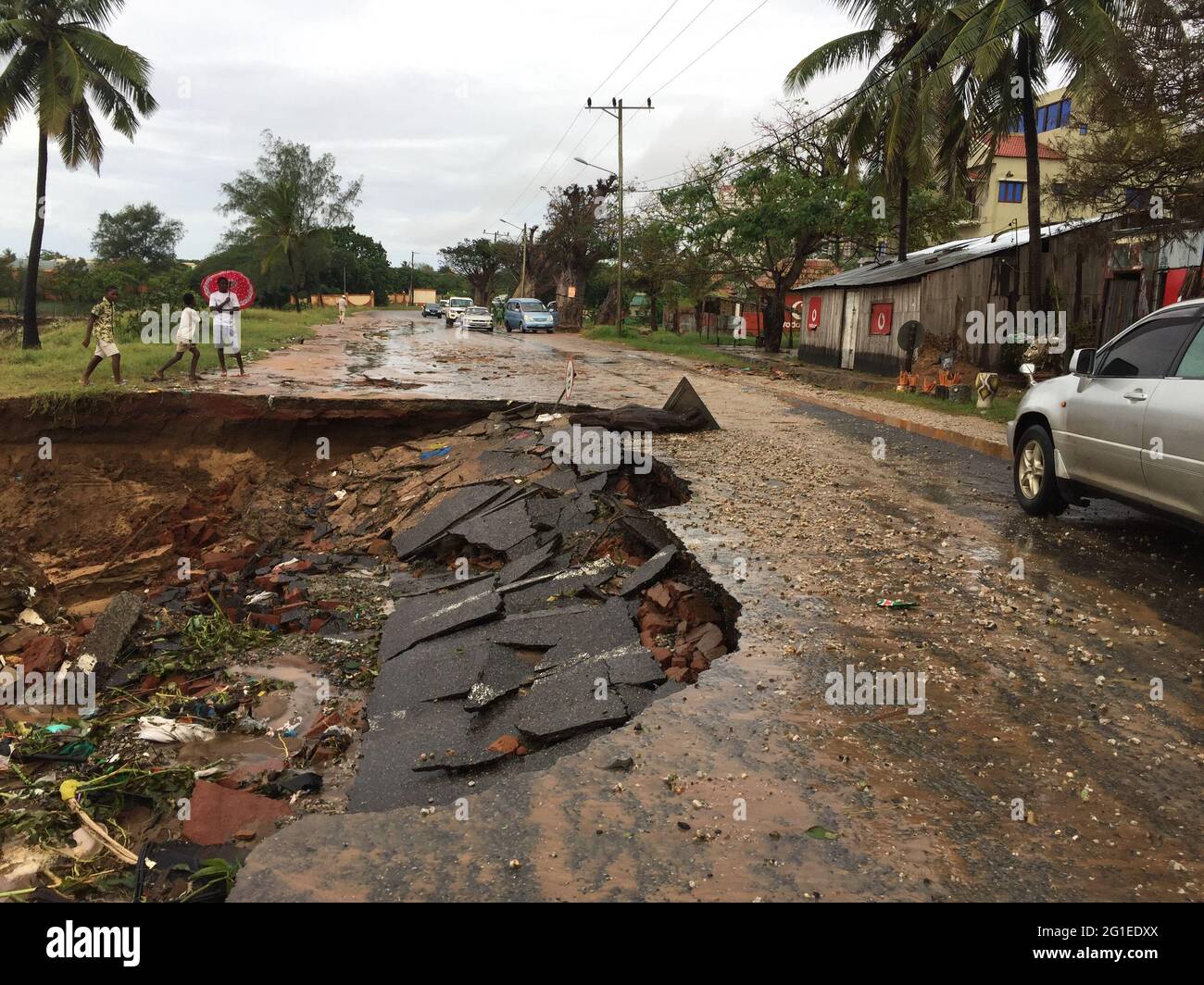 Damaged houses and roads in African town after Hurricane Kenneth Stock ...