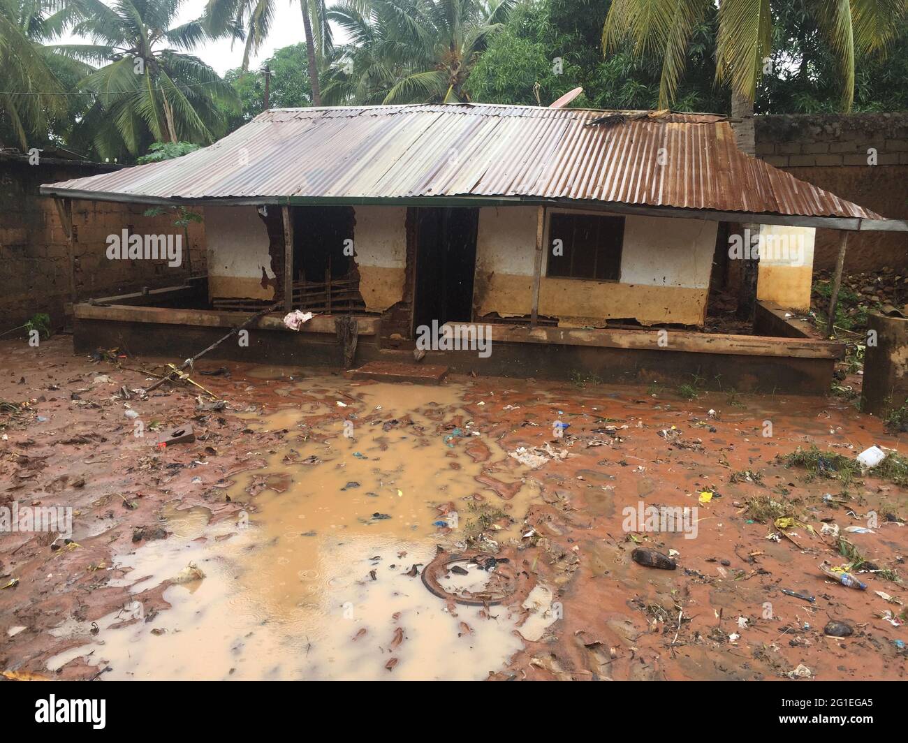 Damaged houses and roads in African town after Hurricane Kenneth Stock ...