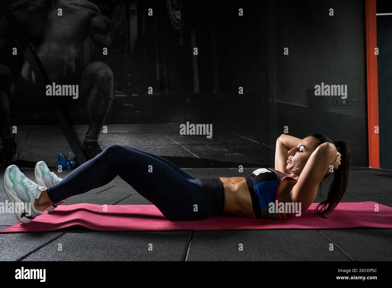 Athletic young woman doing crunches during workout in gym Stock Photo ...