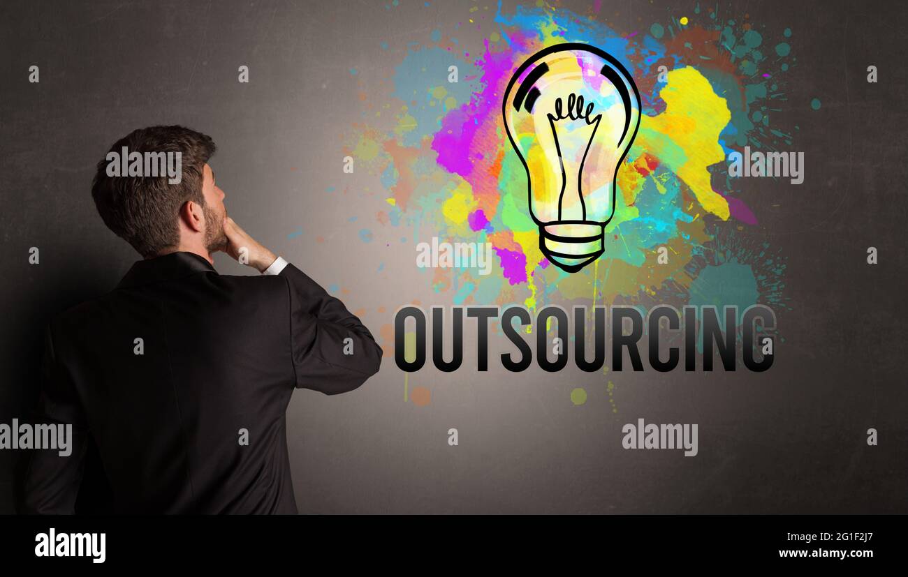 businessman drawing colorful light bulb Stock Photo - Alamy