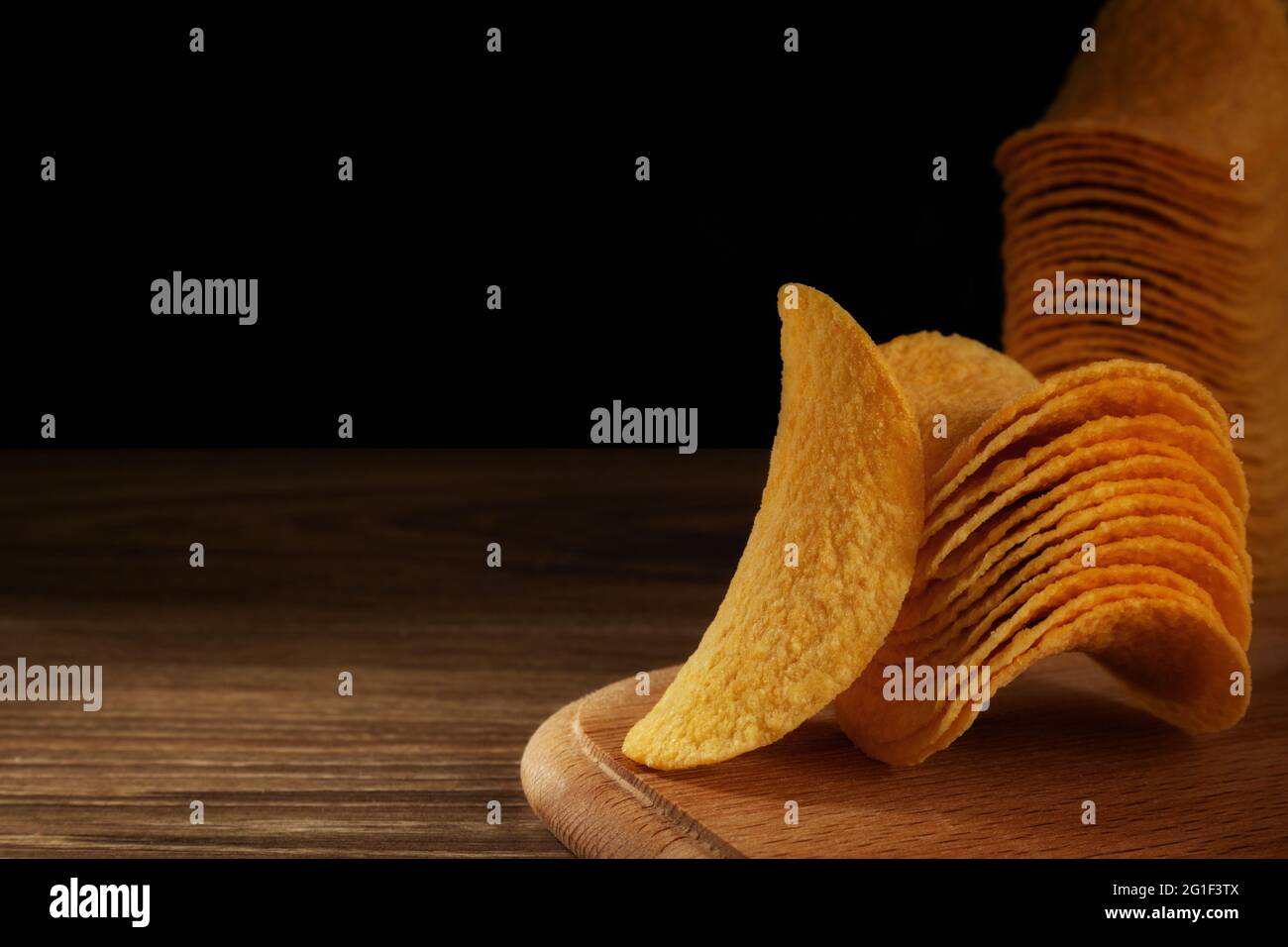 Pyramid of potato chips on a wooden background and free place Stock ...