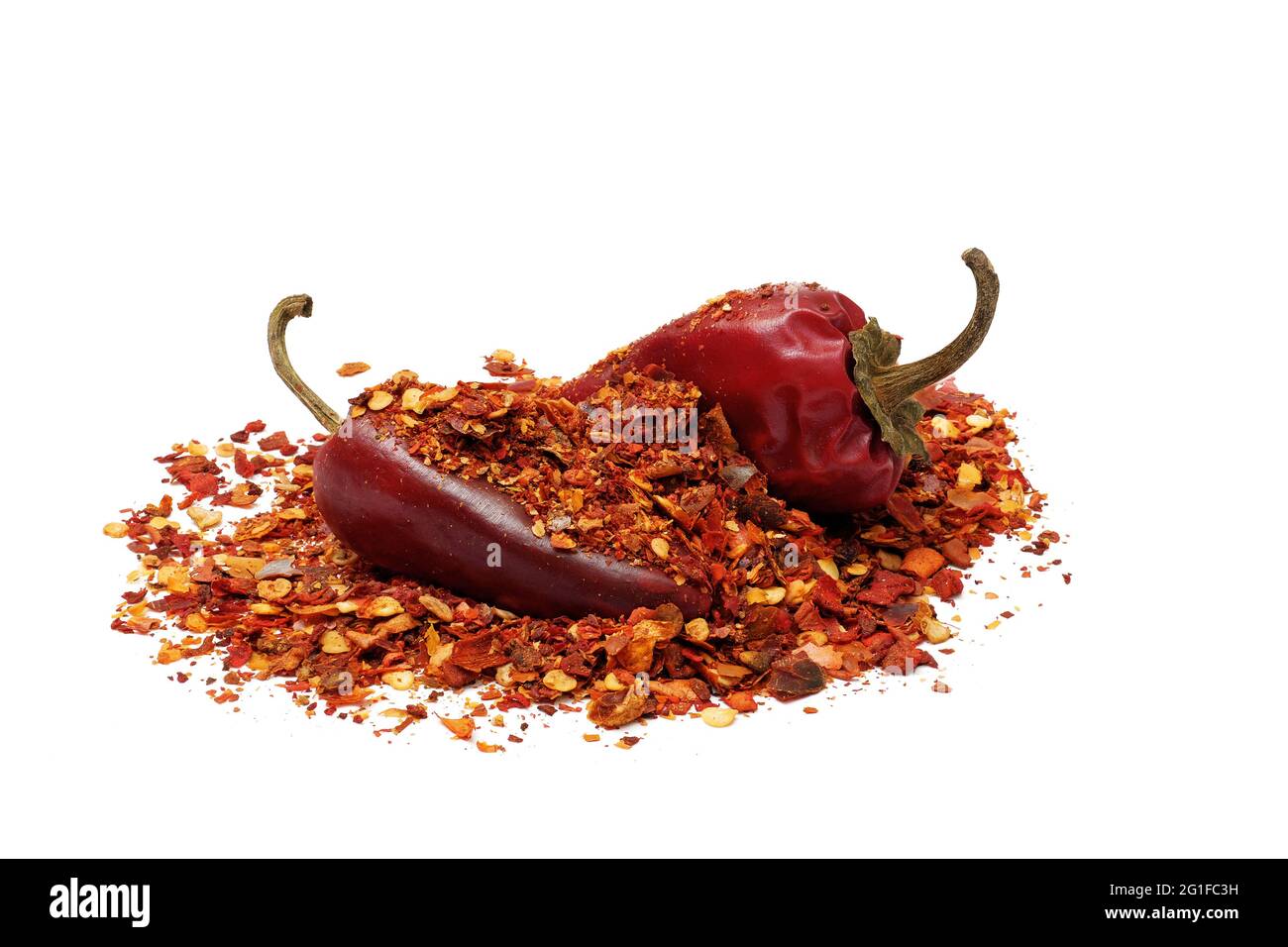 heap of ground dried chili pepper flakes and pods isolated on white ...