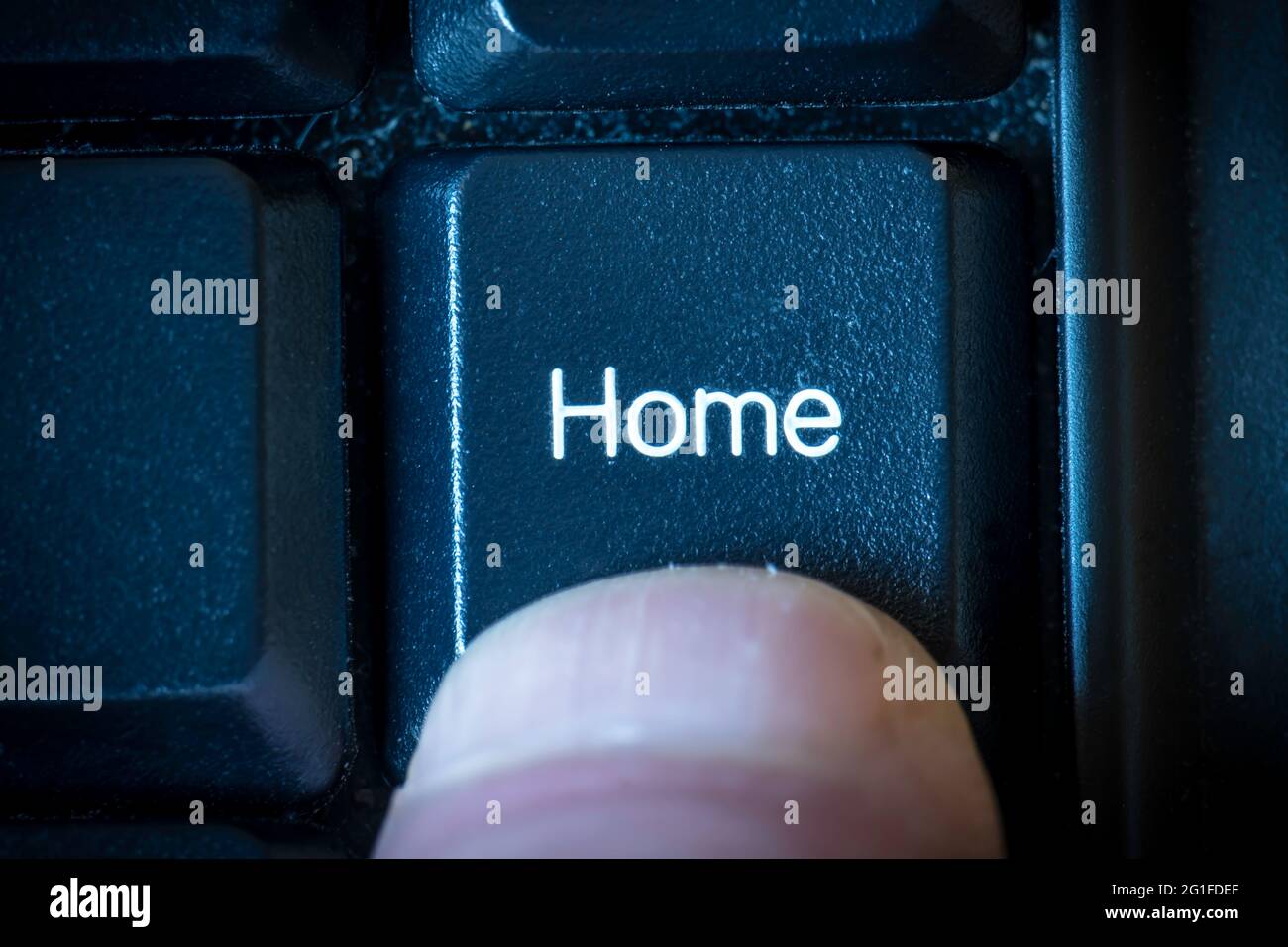 Finger press home on keyboard Stock Photo - Alamy