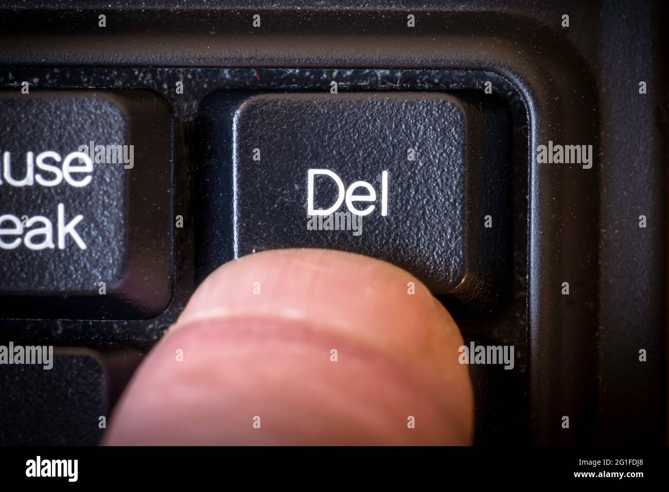 Finger press delete on keyboard Stock Photo - Alamy