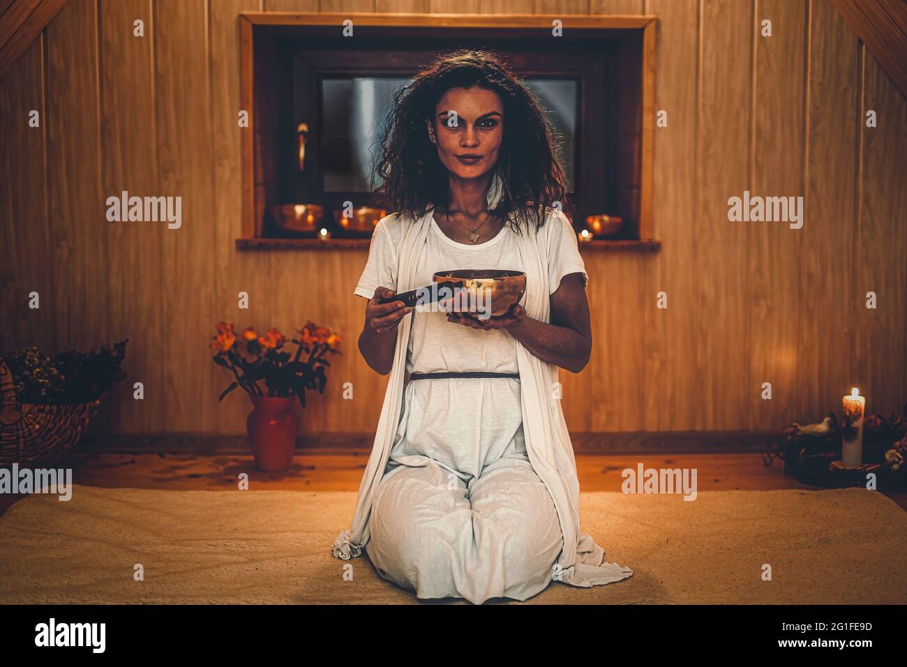 Spiritual girl immersed in meditative sounds of tibetian bowl Stock ...