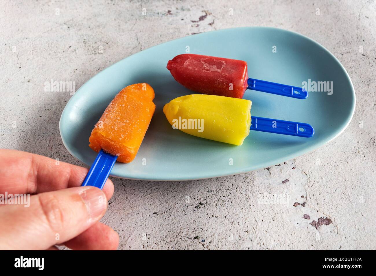 Three mini colored ice creams on white background Stock Photo - Alamy