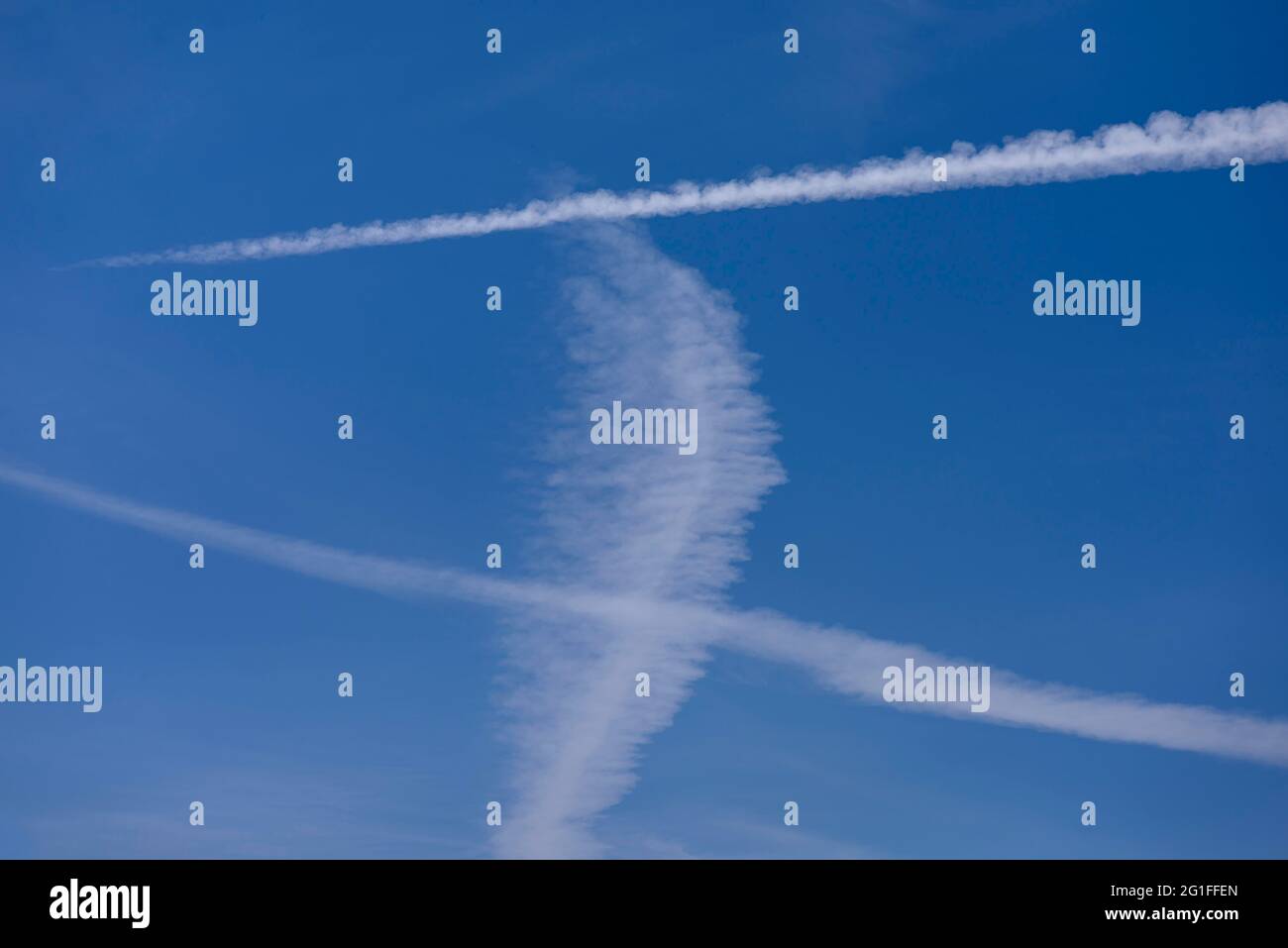 Vapor trails in blue sky, Bavaria, Germany Stock Photo - Alamy