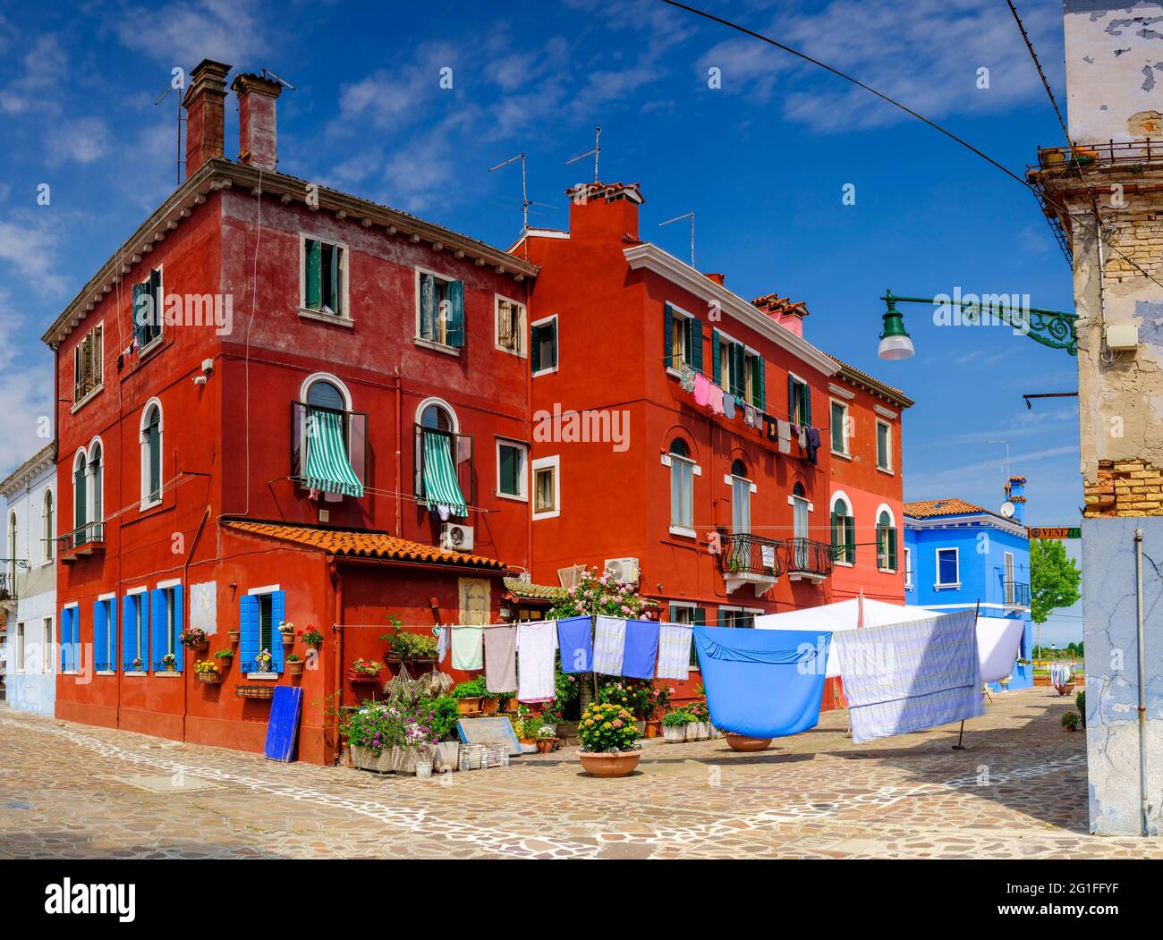 Laundry hanging to dry in the courtyard, colorful facade, Burano Island ...
