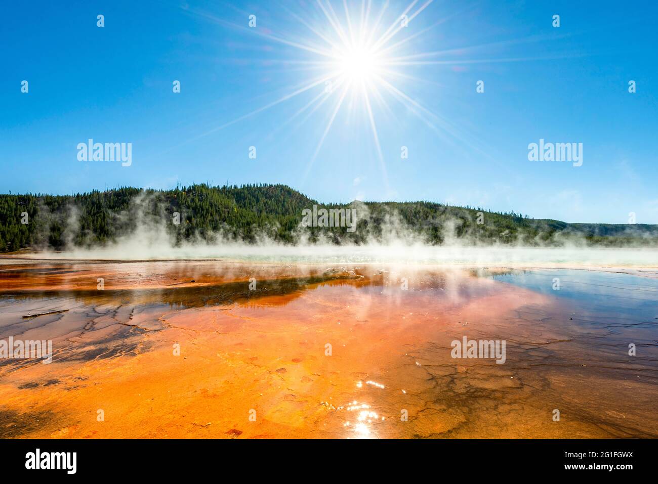 Steaming hot spring with sun star, Colored mineral deposits, Grand ...