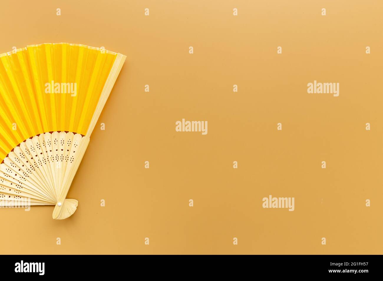 Yellow golden hand fan made of bamboo and paper. Top view Stock Photo ...