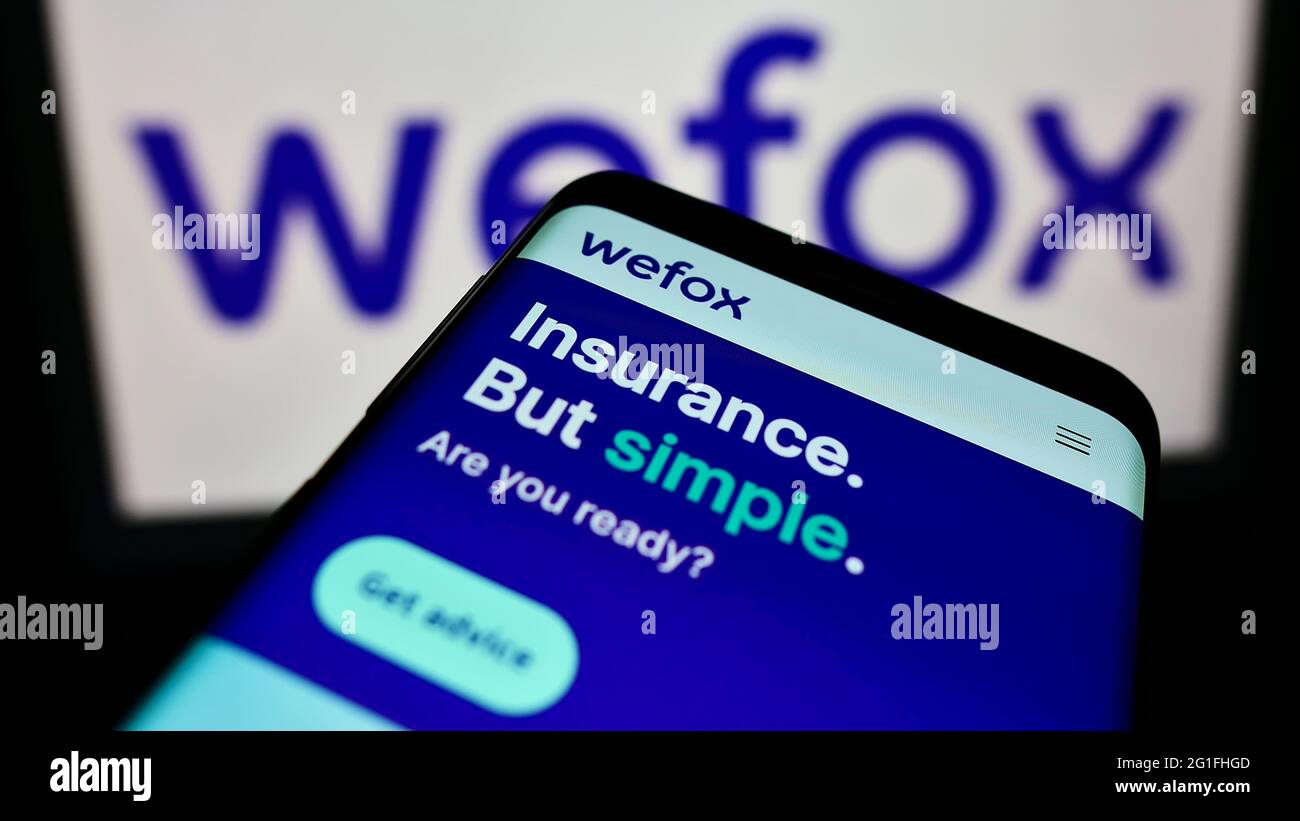 Smartphone with web page of digital insurance company wefox Holding AG ...