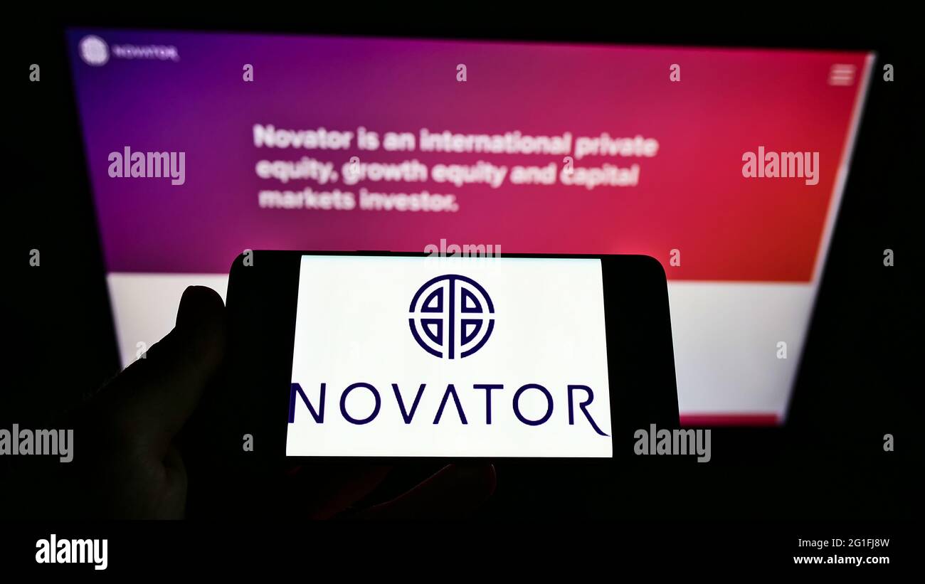 Person holding smartphone with logo of British private equity firm ...