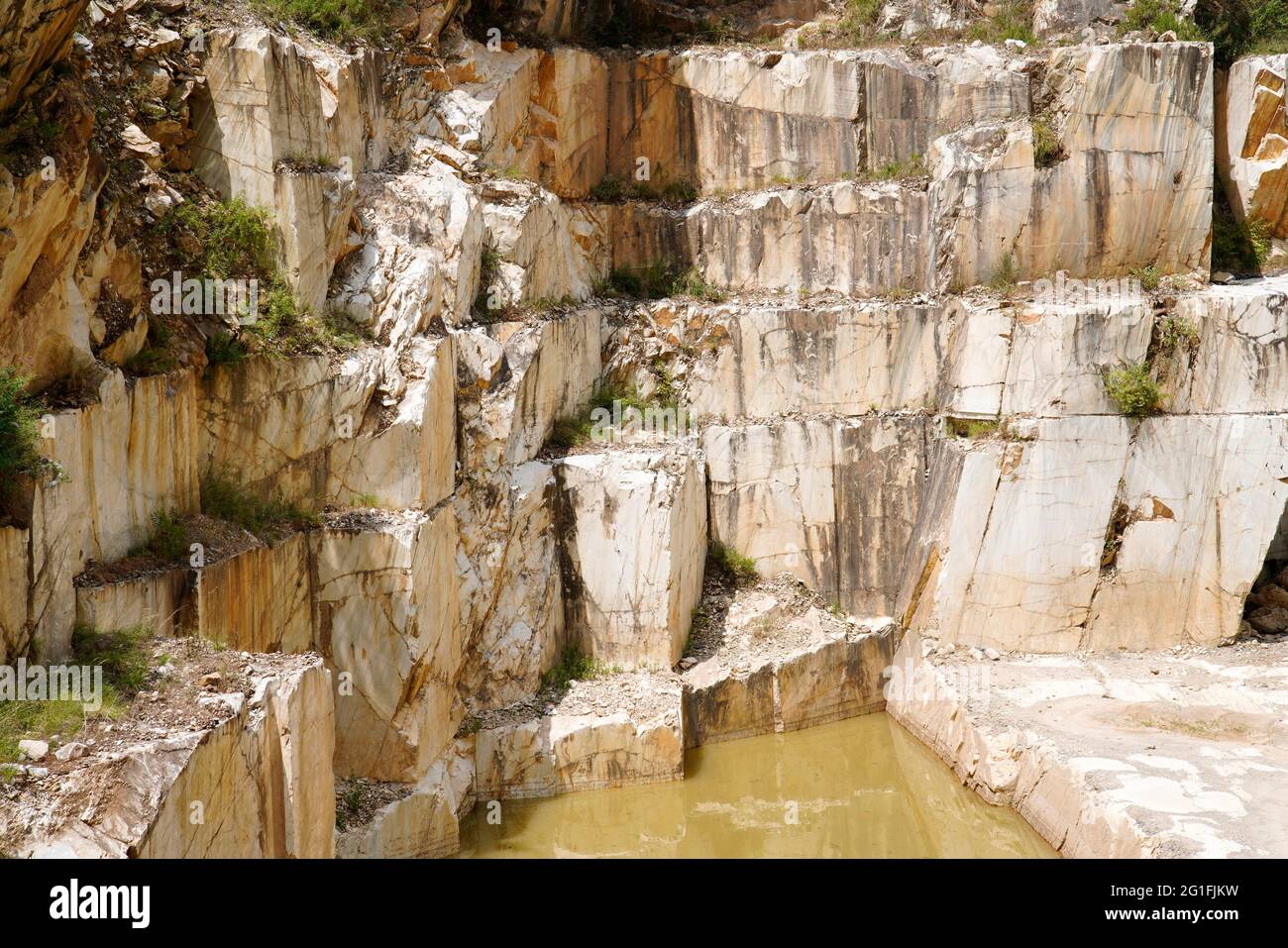 Terraced rock face in open pit carrara marble mines or quarries ...