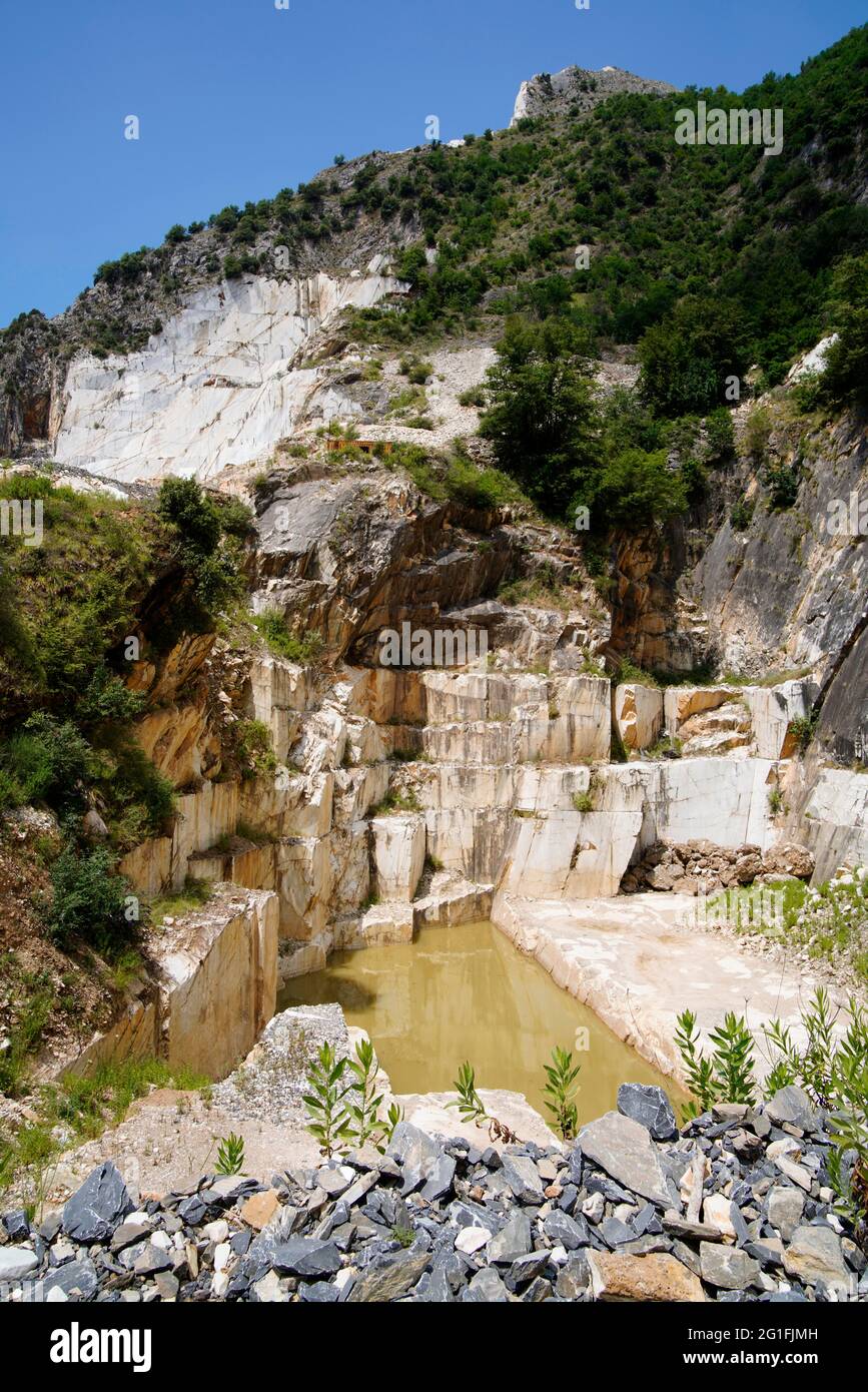 Terraced rock face in open pit carrara marble mines or quarries ...
