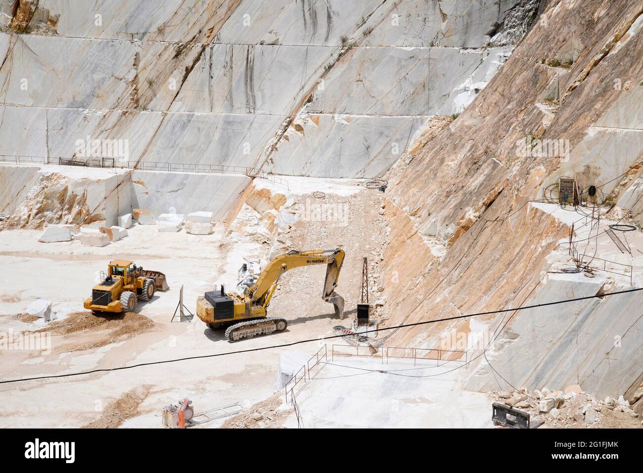 Terraced rock face in open pit Carrara marble mines or quarries ...