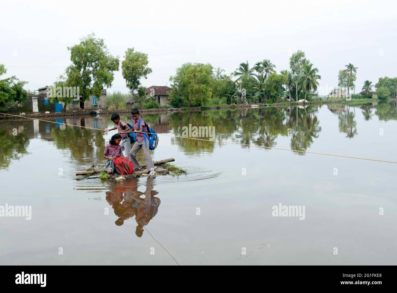 School going boys and a girl crossing the Backwaters with the help of ...
