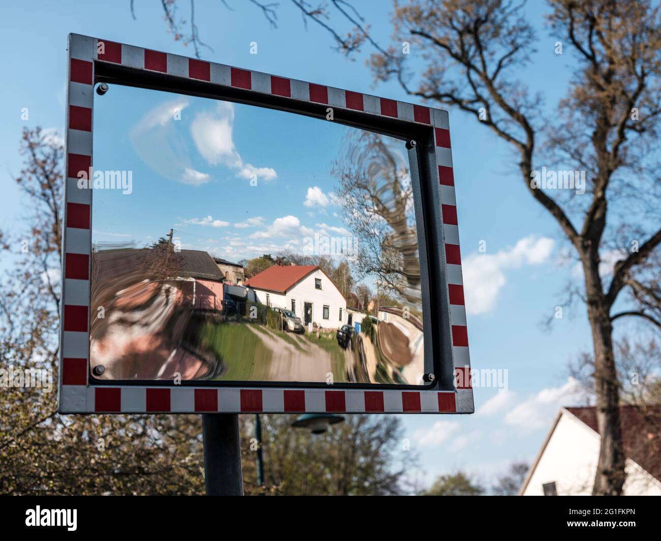 Traffic mirror at intersection in village, sunny, blue sky, Berlin ...