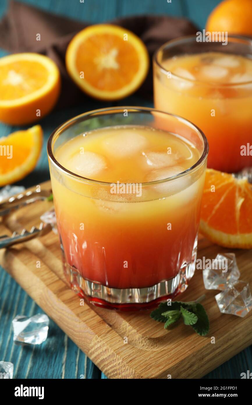 Tequila Sunrise cocktails and ingredients on wooden table Stock Photo ...