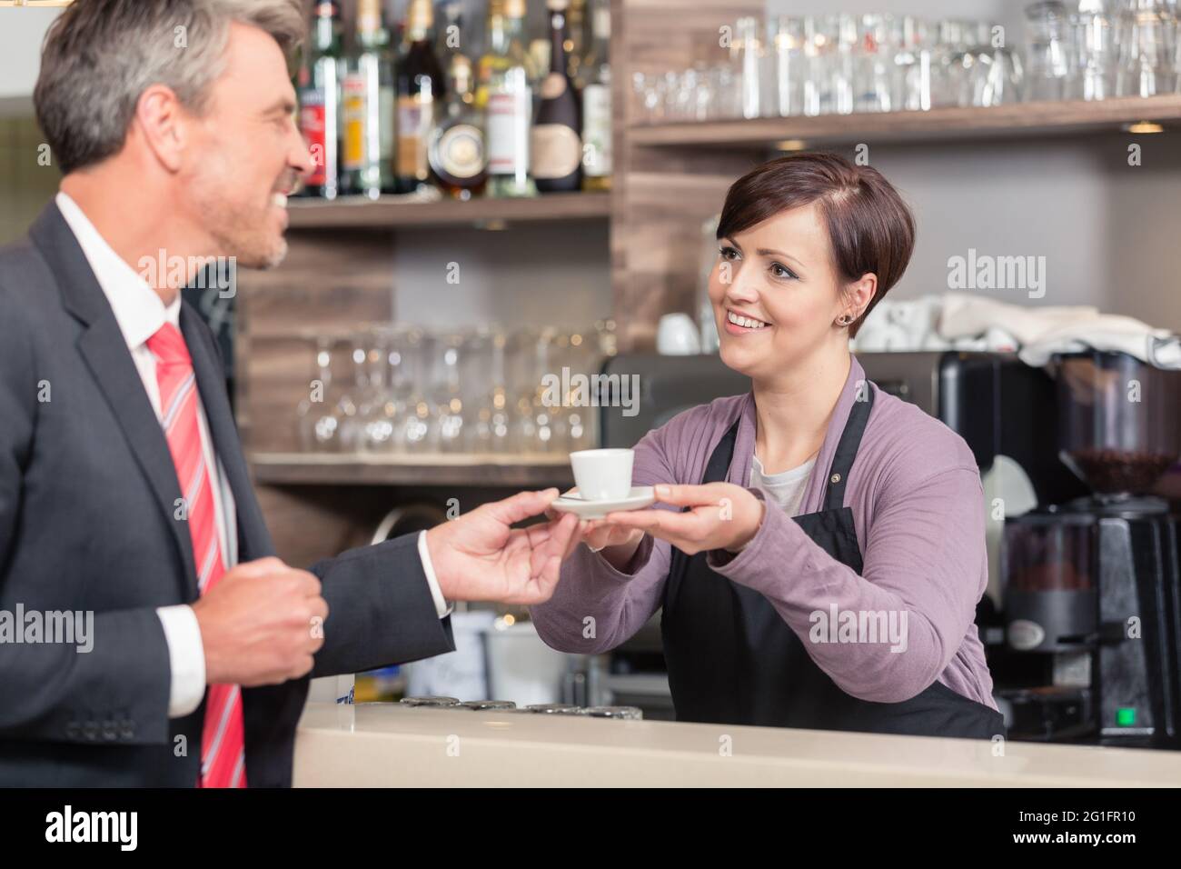 Happy businessman receiving coffee from smiling female waitress Stock ...