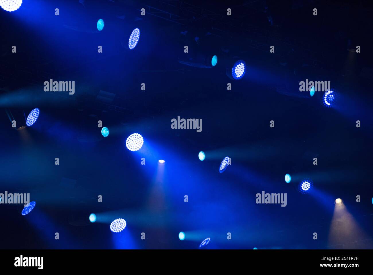 Blue stage lights glowing in the dark. Live music festival concept ...