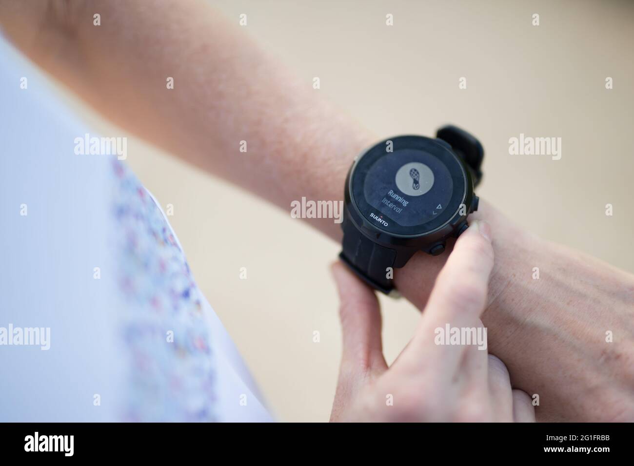 Girl looking at the watch after running Stock Photo - Alamy