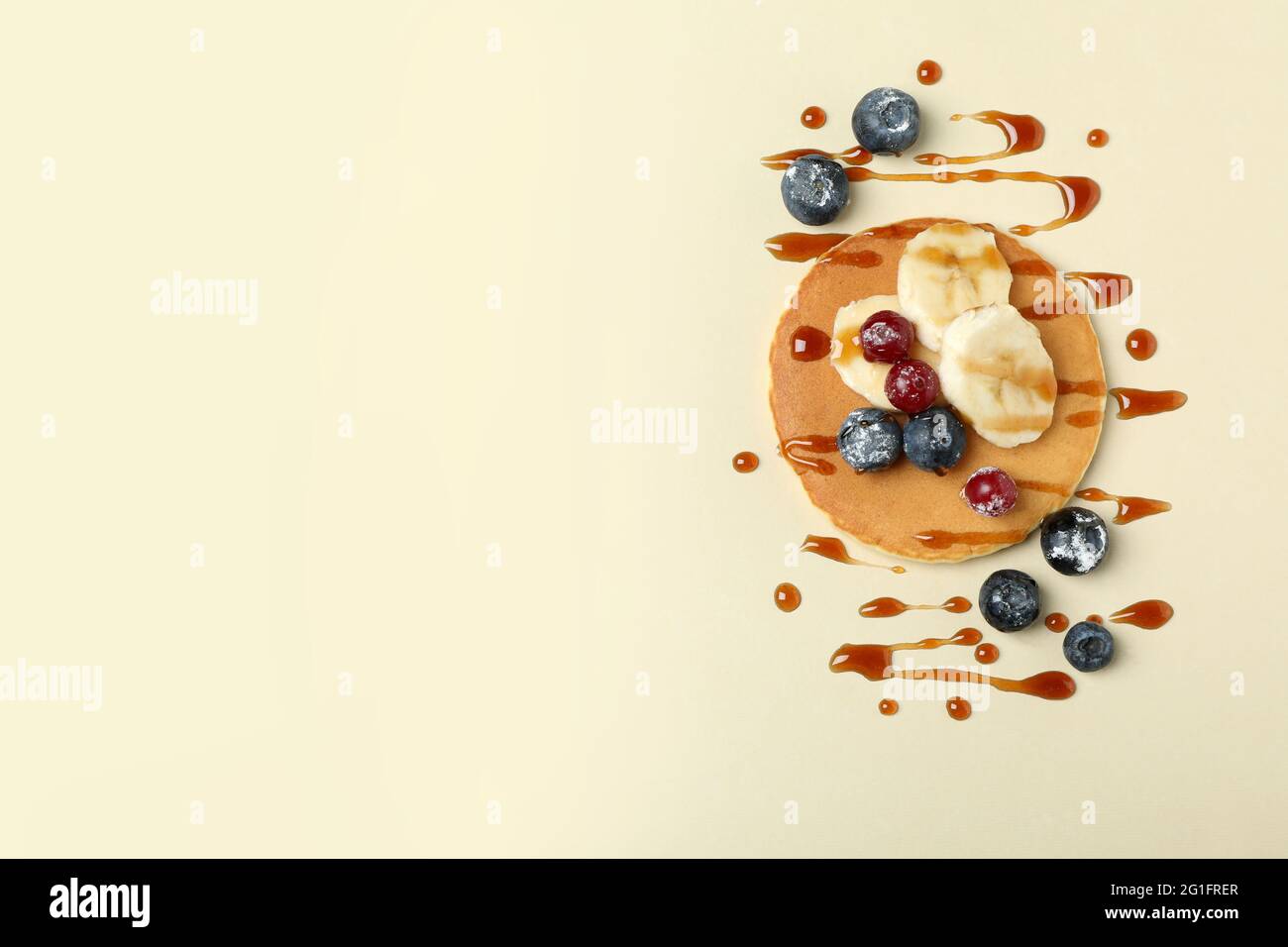 Concept of tasty food with pancake on beige background Stock Photo - Alamy