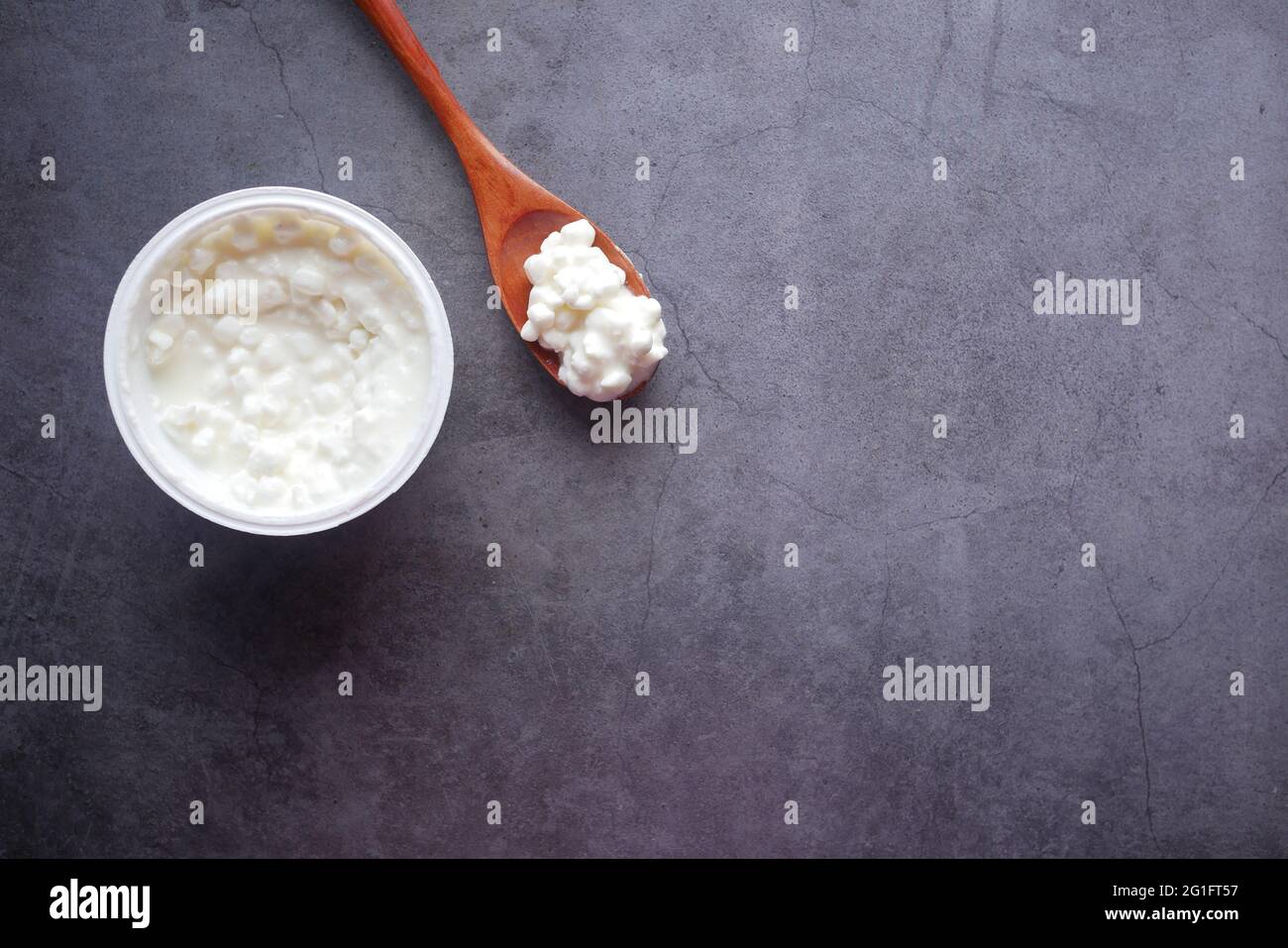 feta cheese in a container on black background Stock Photo - Alamy