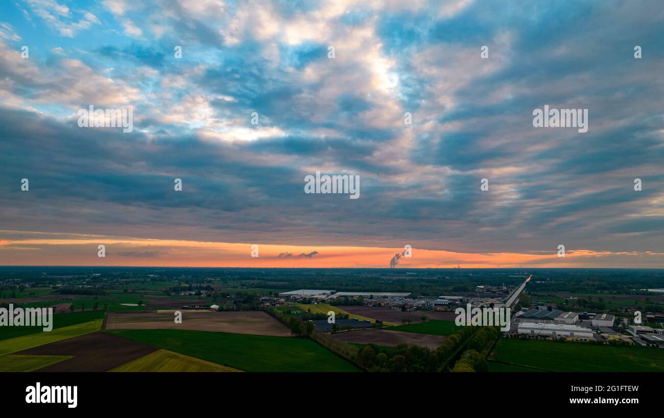 Sunset with dark and dramatic tthunderstorm clouds being split. The ...