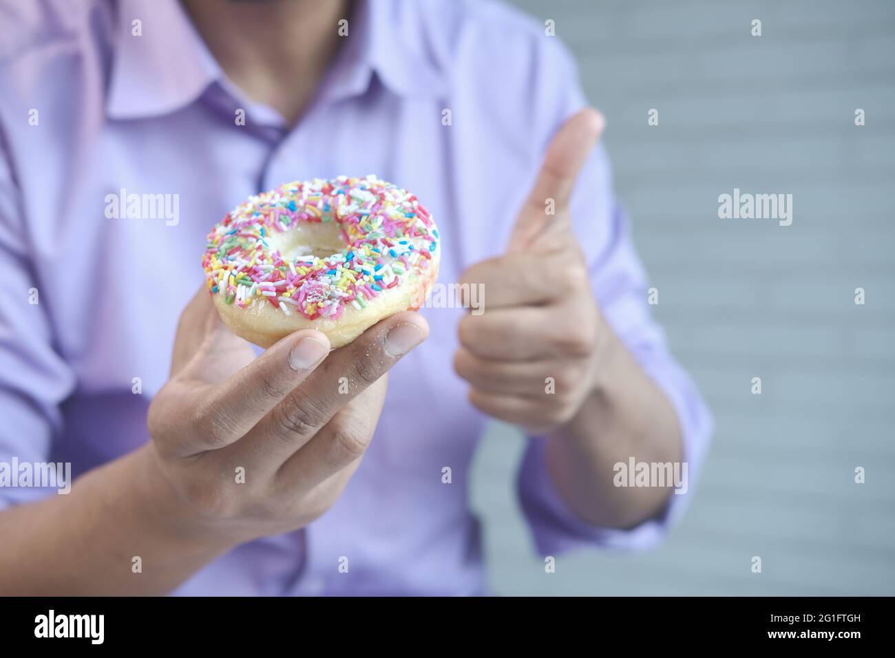 Holding up donuts hi-res stock photography and images - Alamy