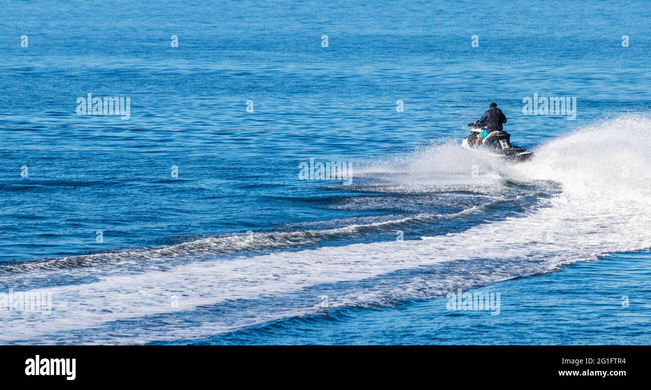 Closeup shot of a tourist driving a jet ski on the water Stock Photo ...