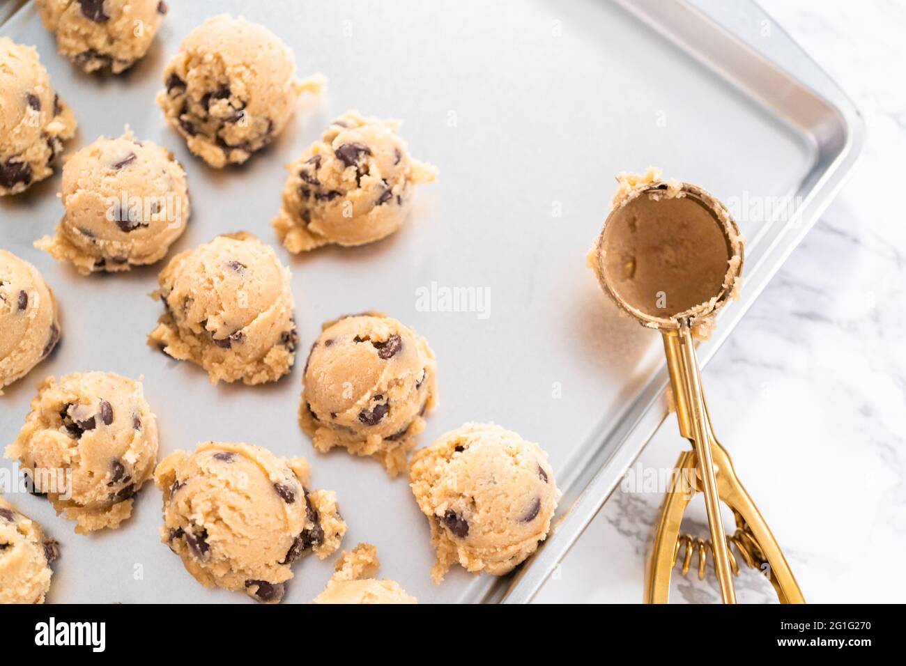 Homemade chocolate chip cookies dough scoops on a baking sheet Stock ...