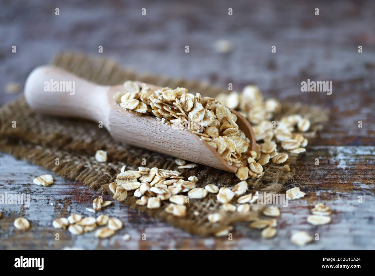 Oatmeal on wooden background in a wooden spatula Stock Photo - Alamy