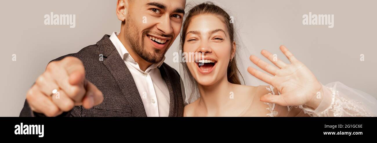 Cheerful man waving hand pointing hi-res stock photography and images ...