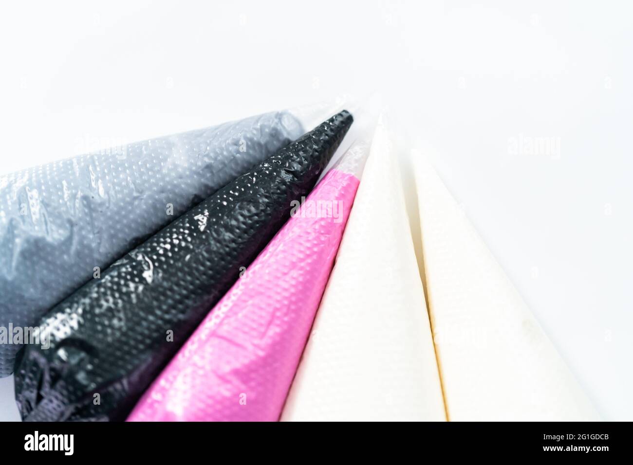 Pink, black, and white royal icing in piping bags Stock Photo - Alamy