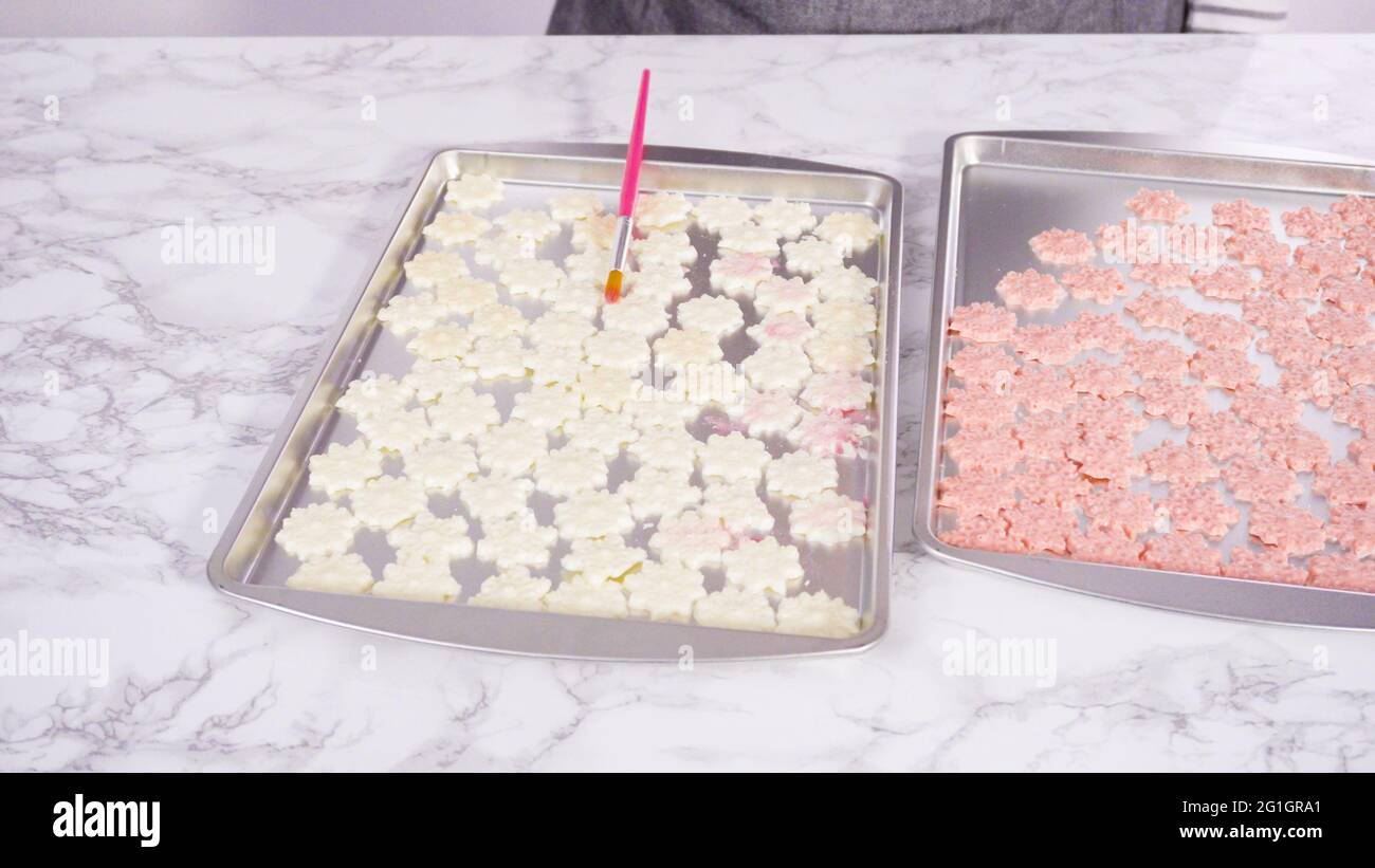 Step by step. Dusting chocolate snowflakes with glittery food dust ...