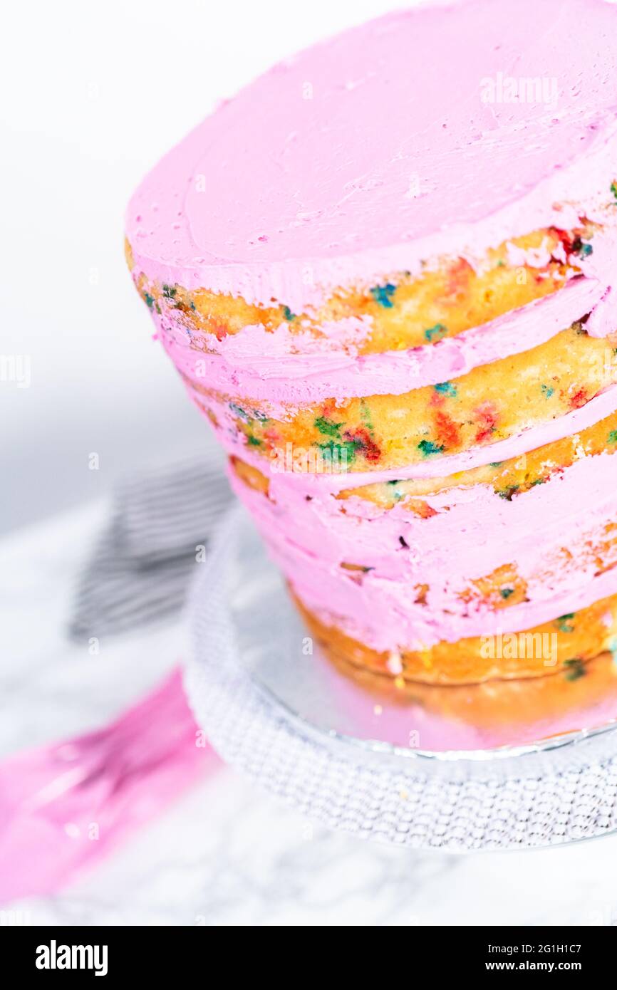 Funfetti cake layers with pink buttercream frosting Stock Photo - Alamy
