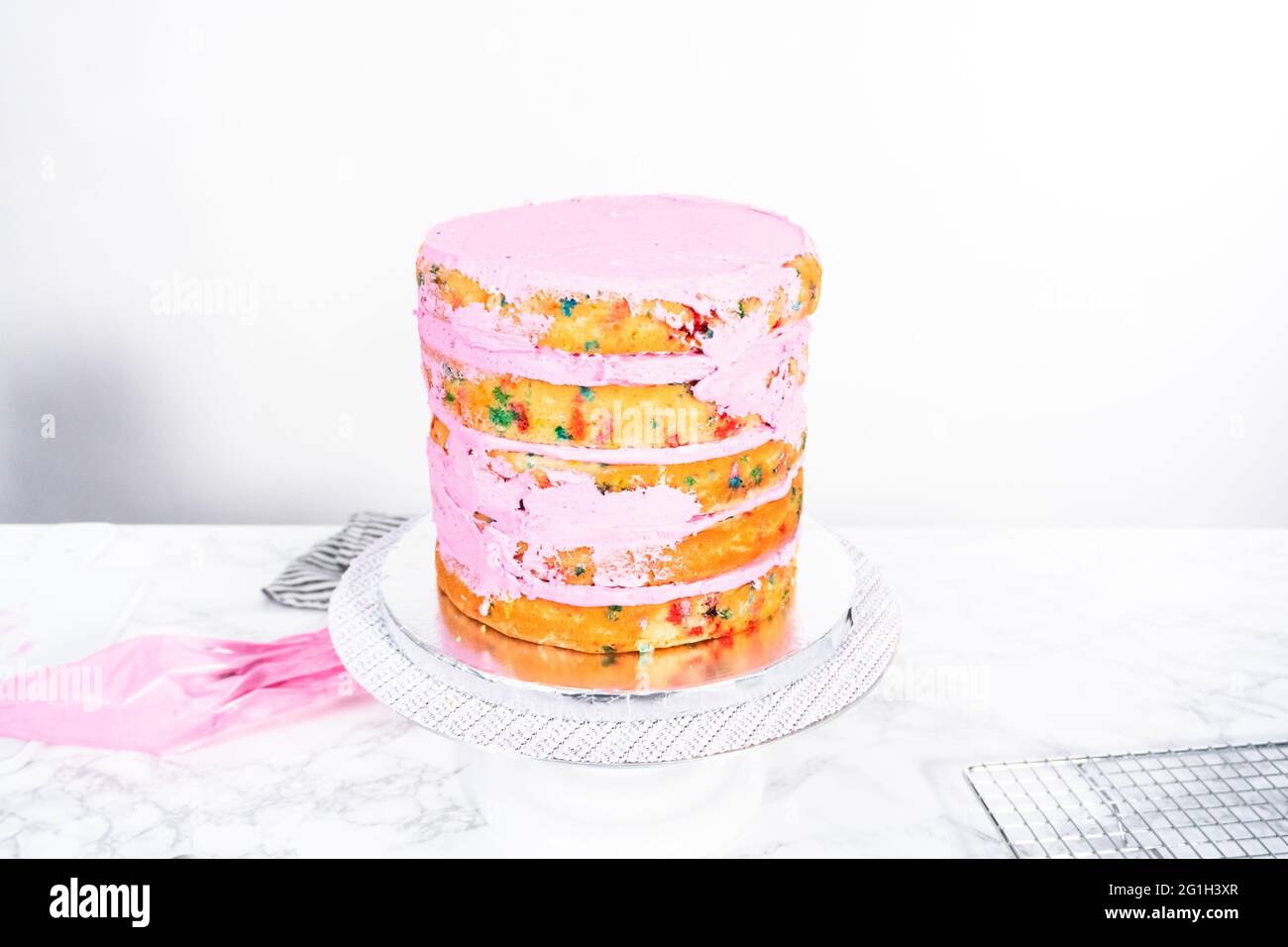 Funfetti cake layers with pink buttercream frosting Stock Photo - Alamy