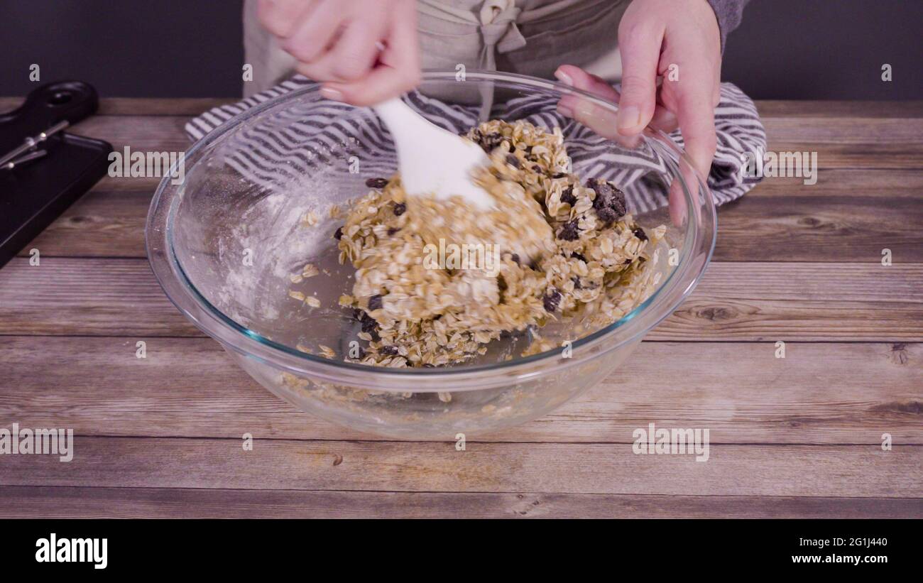 Step by step. Mixing ingredients to bake oatmeal raising cookies in a ...