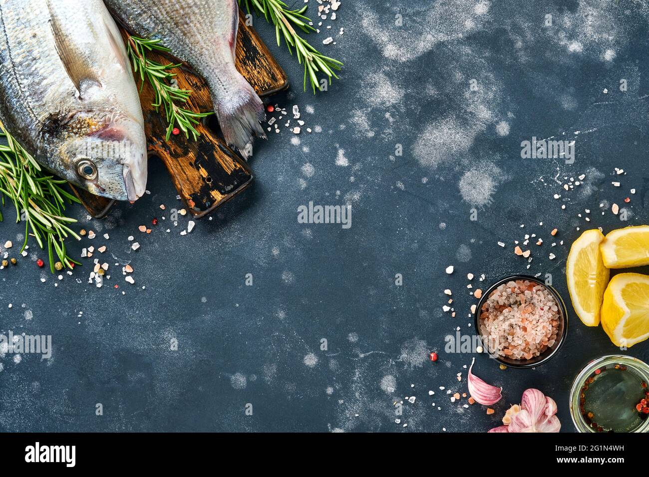 Raw dorado fresh fish or sea bream with ingredients for making lemon ...