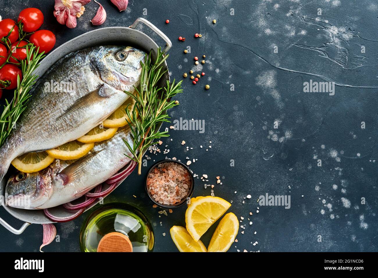 Raw dorado fresh fish or sea bream with ingredients for making lemon ...