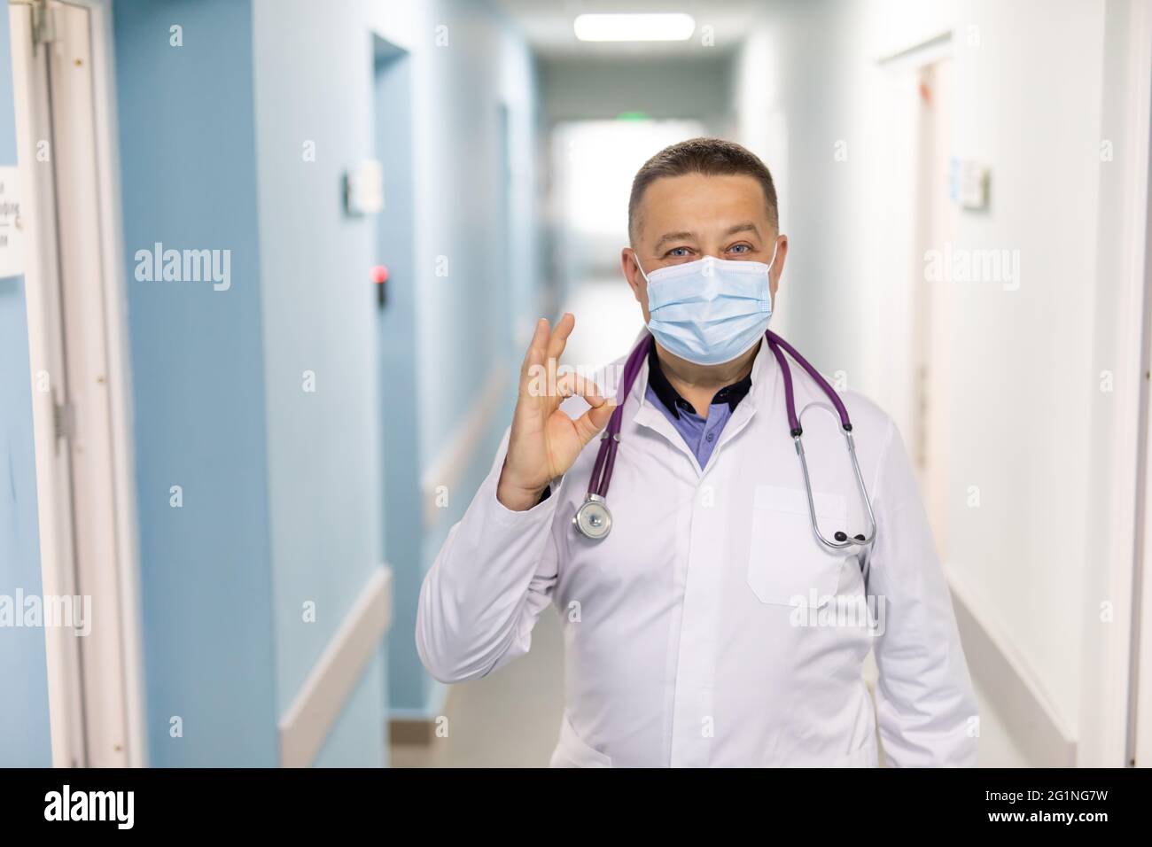 Happy cheerful male doctor is showing ok sign. Making circle with ...