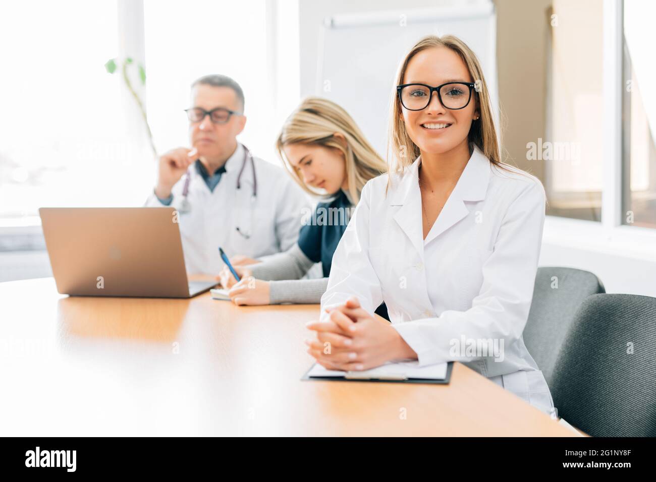 Medical doctors team meeting around table in modern hospital Stock ...