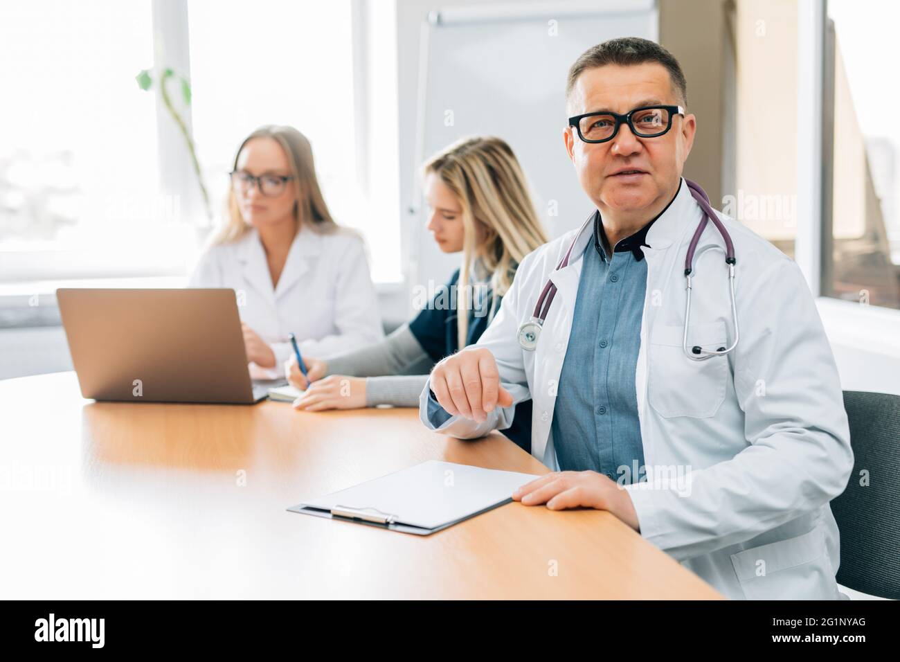 Medical doctors team meeting around table in modern hospital Stock ...