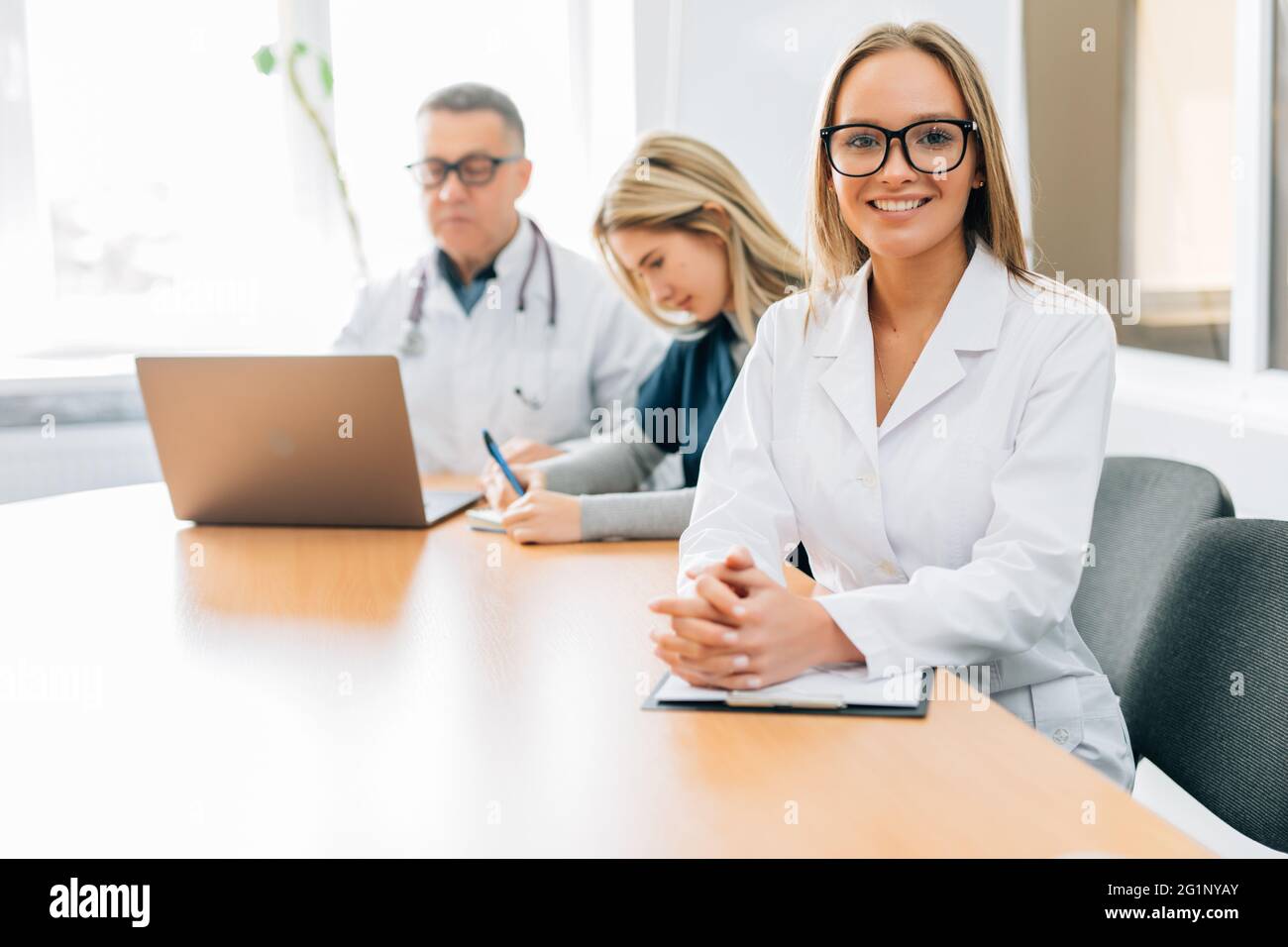 Medical doctors team meeting around table in modern hospital Stock ...