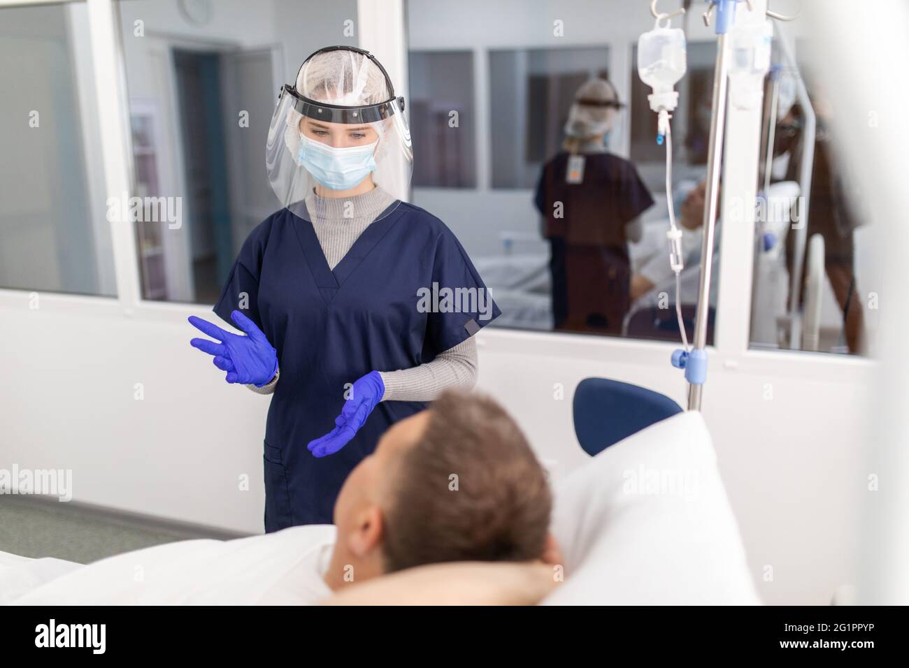 Woman Doctor wearing PPE suit and Surgical mask and Checking infected ...