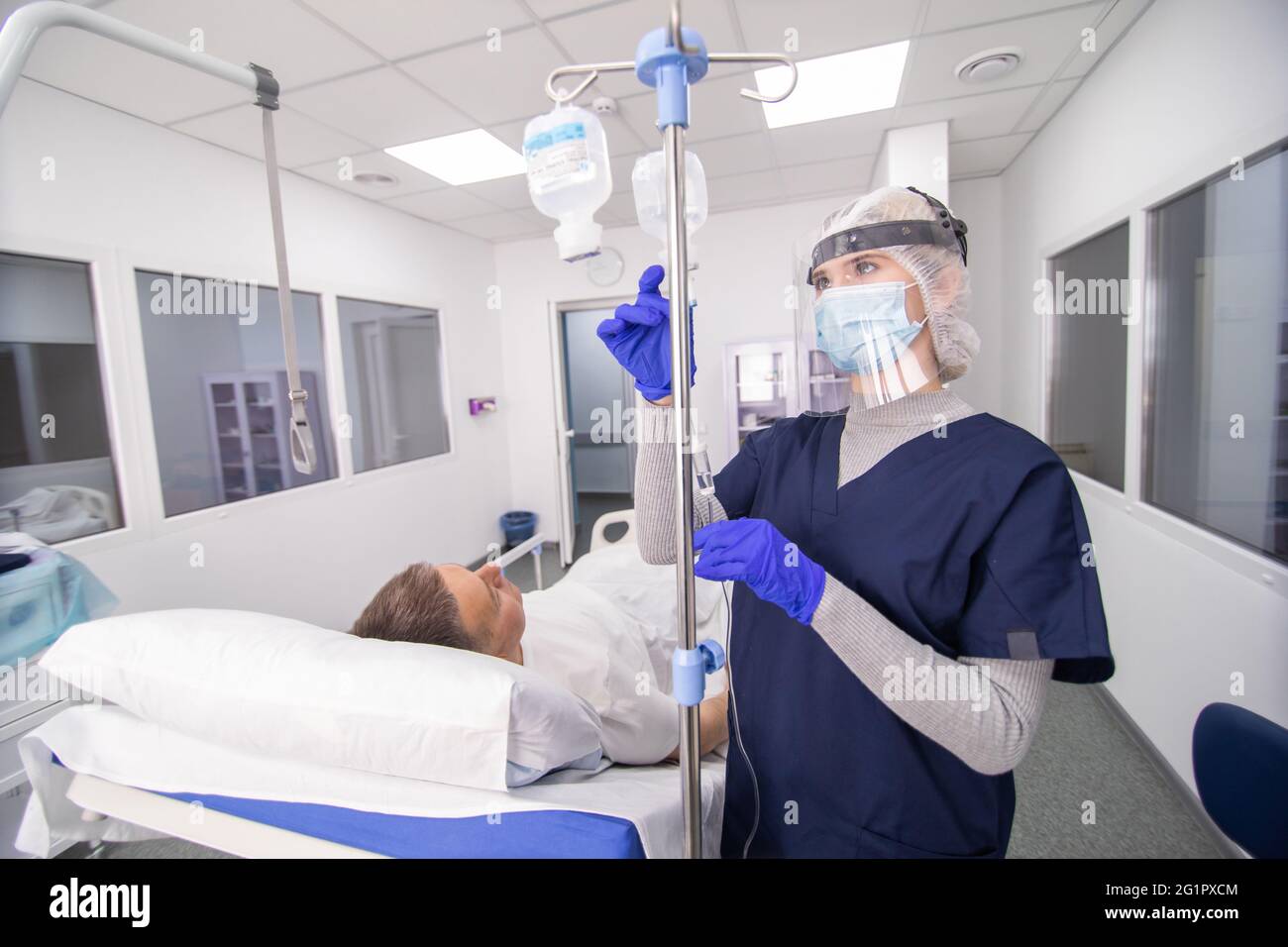 Adult patient lying on bed during intravenous injection by dropping ...