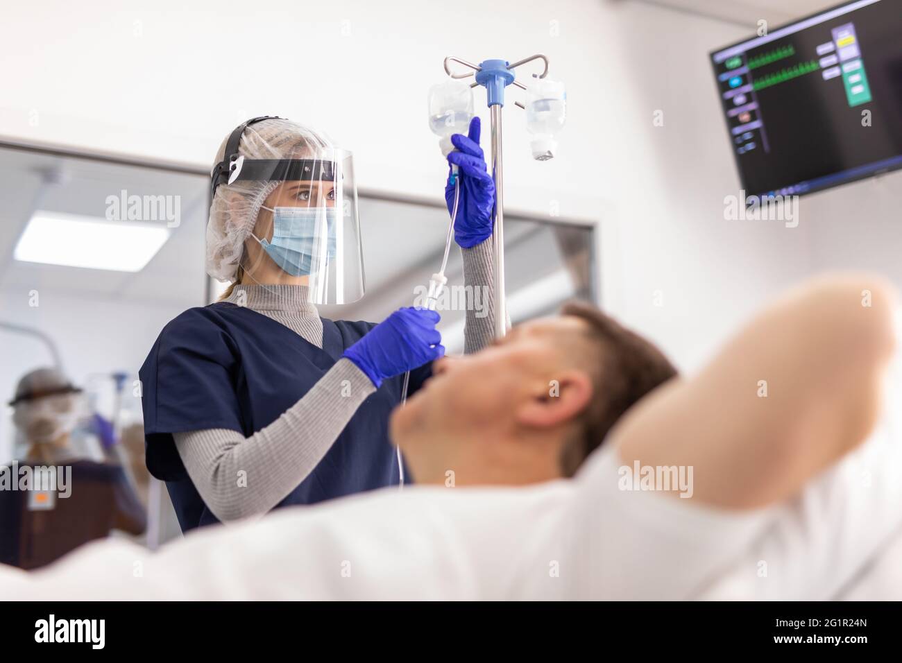 Adult patient lying on bed during intravenous injection by dropping ...