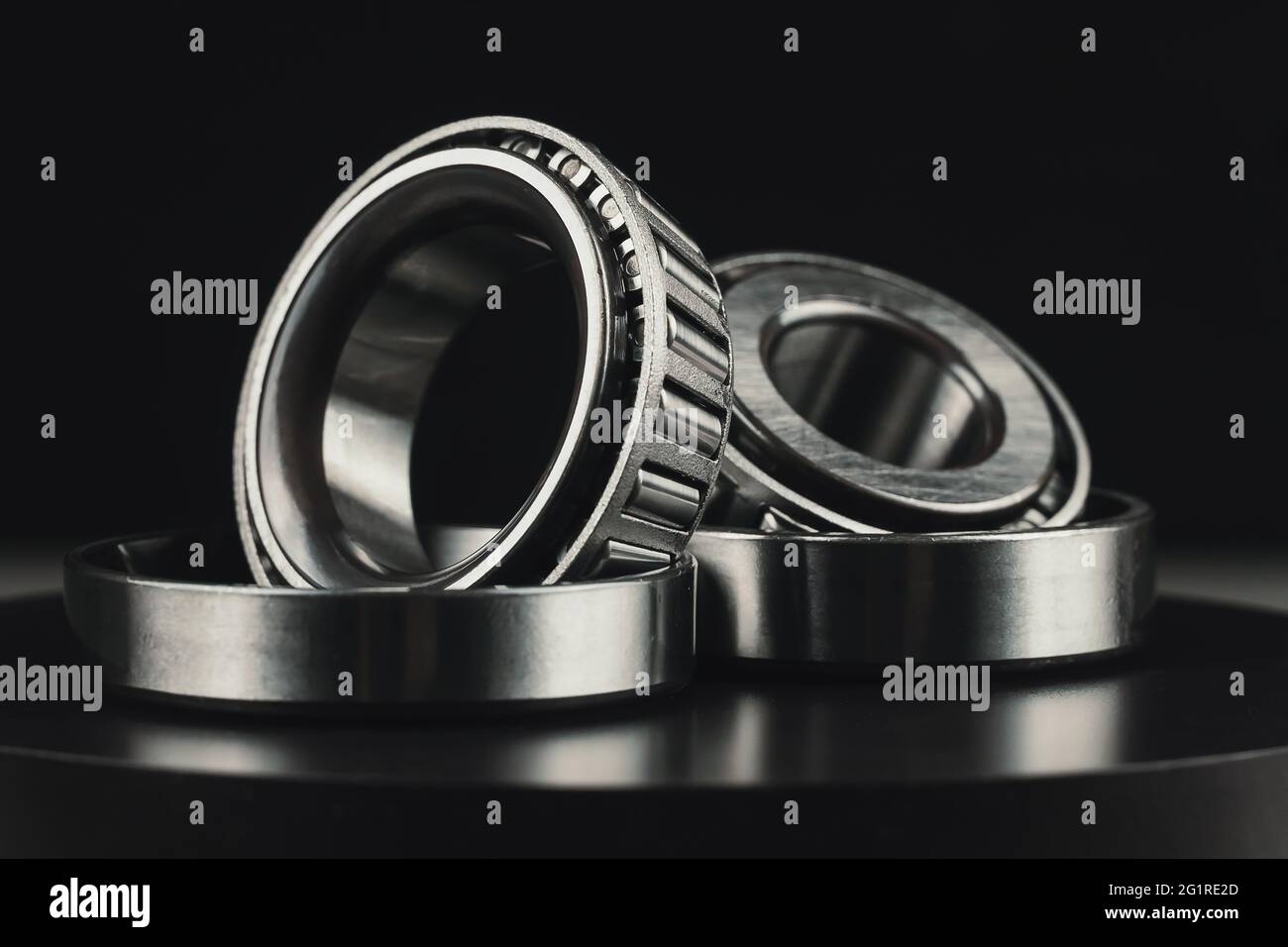 Two new car bearings on a black background close up Stock Photo - Alamy