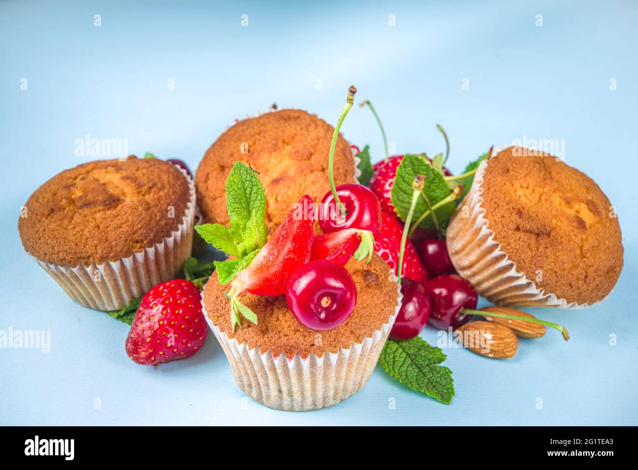 Summer baking concept, homemade vanilla white muffins with berry ...