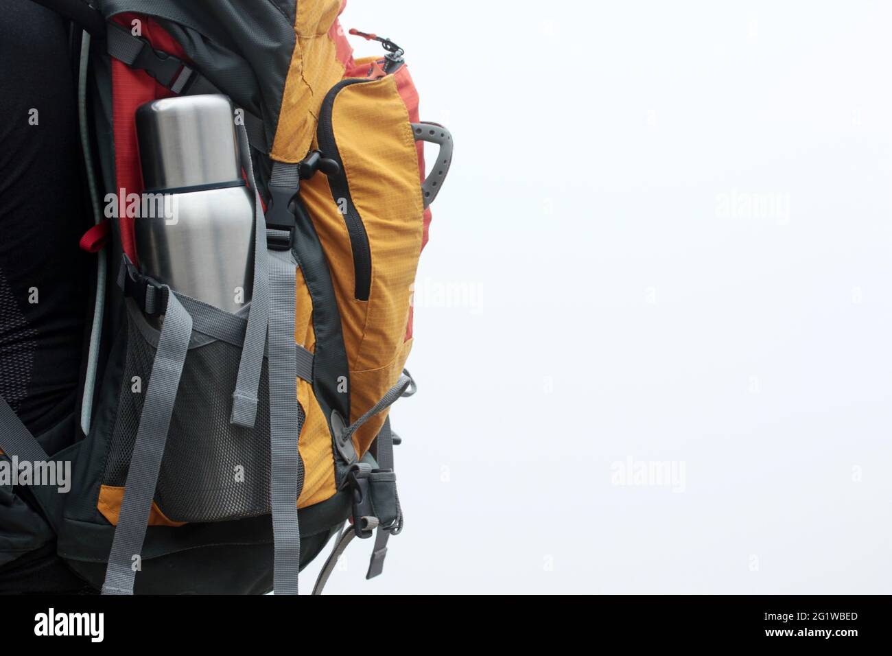 Steel thermos in the pocket of the backpack. Tourist Traveler bag ...